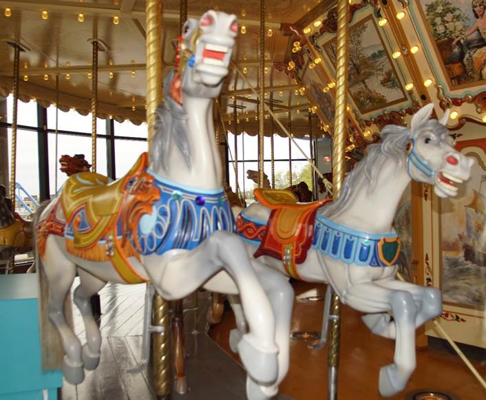 A picture containing carousel, outdoor object, ride, indoorDescription ...