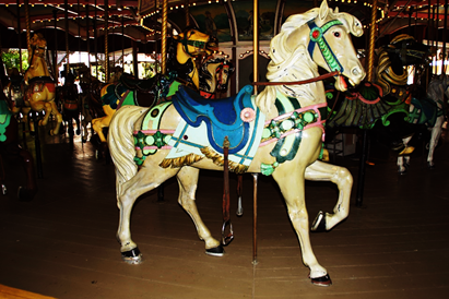 A person standing in front of a carouselDescription automatically generated