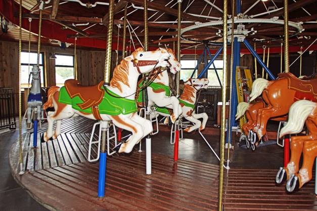 A carousel with horses on itDescription automatically generated