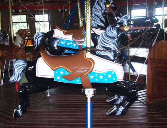 A carousel with horses on itDescription automatically generated